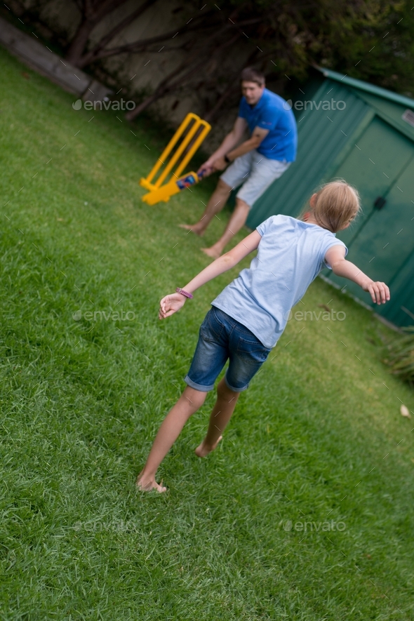 Father and daughter enjoy backyard cricket. Family fun Stock Photo by ...