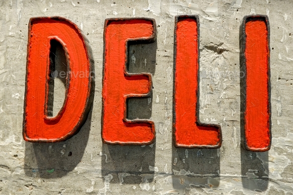 Deli. Delicatessen store sign on a concrete wall Stock Photo by Daria_Nipot