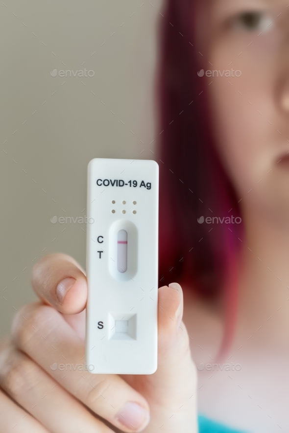 Teenage girl with negative Covid-19 Antigen Rapid test result. Express ...