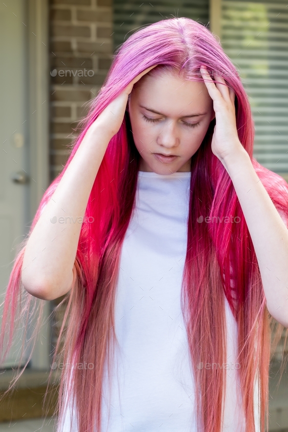 Unhappy stressed Teenage girl with pink purple ombré colored hair ...