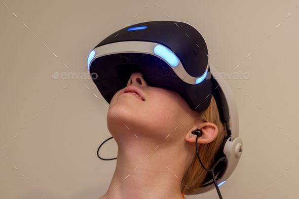 Teenage girl wearing VR headset looking up. Using technology. Gaming ...