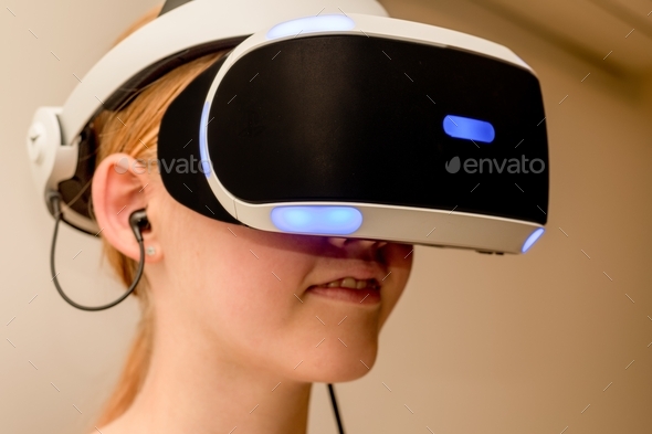 Teenage girl wearing VR headset. Using technology. Gaming Stock Photo ...