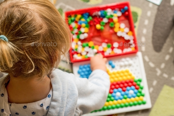 Toddler child early development. Mosaic pegboard game Stock Photo by ...