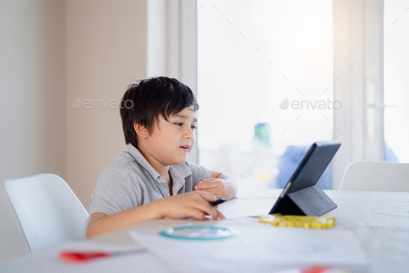 Authentic Kid doing online homework with friends at home, Child using ...