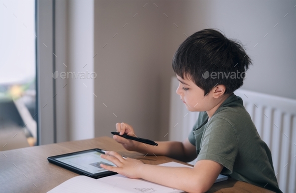 Kid self isolation using tablet for his homework,Child boy using ...
