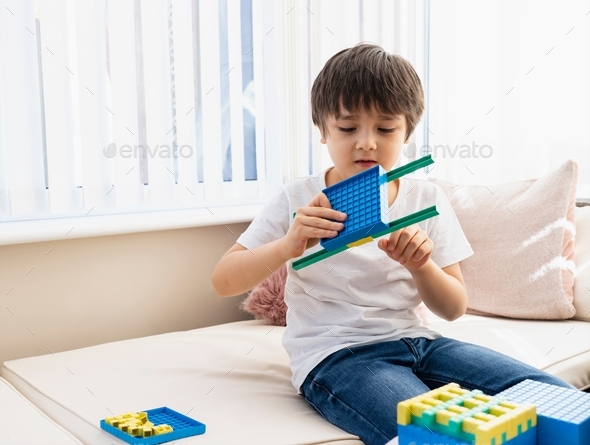 School kid using plastic block counting number, Child boy studying math ...