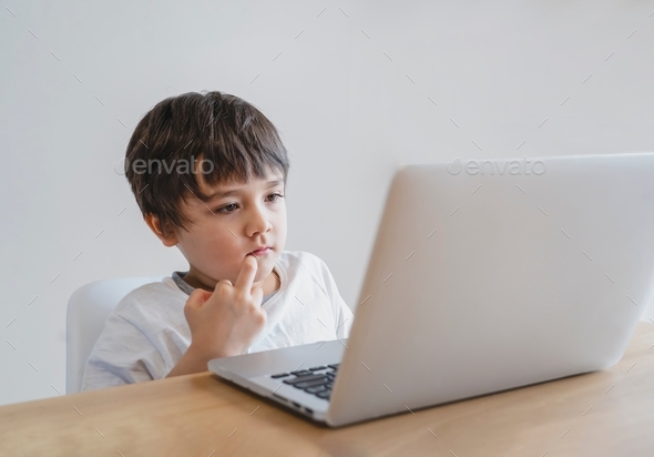 kid using laptop for his homework, child boy use computer for home ...