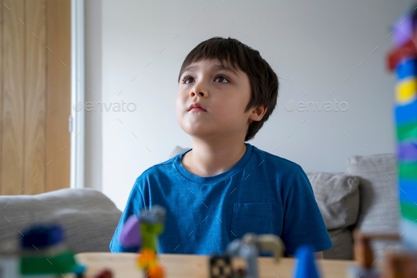 Portraits kid sitting on sofa looking up watching TV, Child watching ...