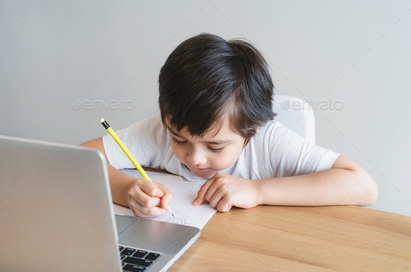 Kid using computer for his homework,Child using laptop searching ...