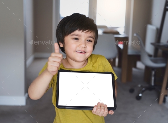 kid with smiling face holding tablet and showing thumb up, child boy ...