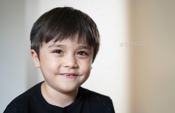 head shot kid looking at camera with smiling face with copy space ...