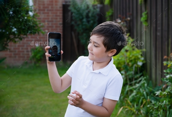 boy showing his photo on mobile phone,Child using camera on smart phone ...