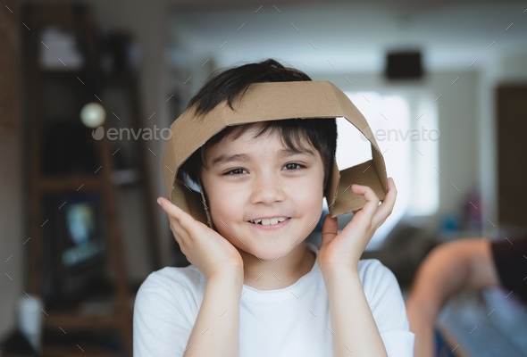 Happy young boy using cardboard for headphone, Active Kid with big ...