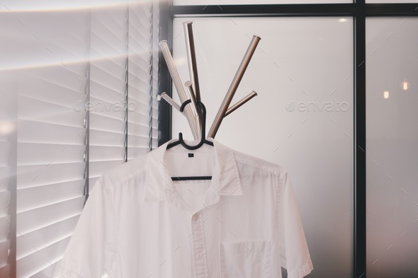 White shirt on rack Stock Photo by wikornr | PhotoDune