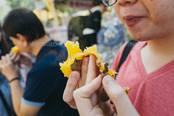 Man eating sweet potato Stock Photo by wikornr | PhotoDune