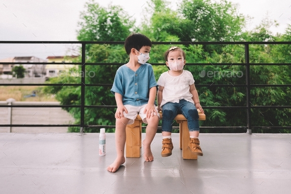 Brother and sister sitting on a bench Stock Photo by wikornr | PhotoDune