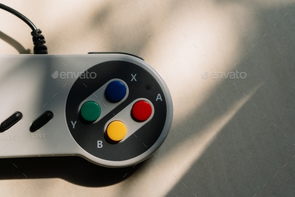 Vintage game controller on the floor in natural dramatic lighting Stock ...