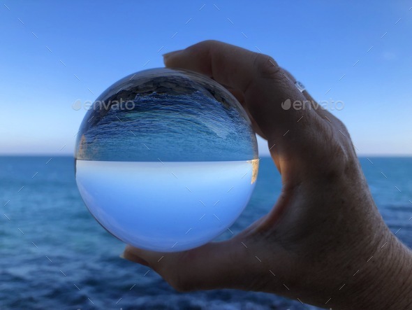 Sea and sky inverted in a crystal ball. Creative Concept, holidays and ...