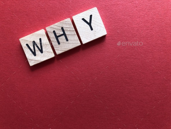 Why, word I n 3D wooden alphabet letters isolated on a plain red ...
