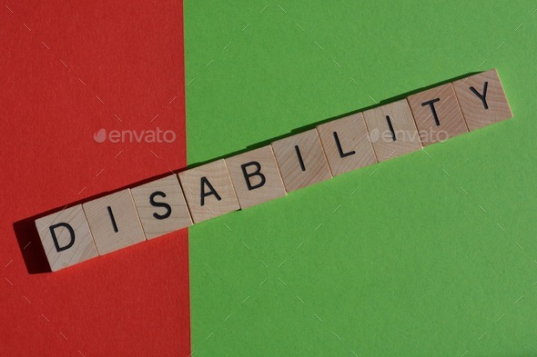 The word Disability in wooden letters on a red and green background ...