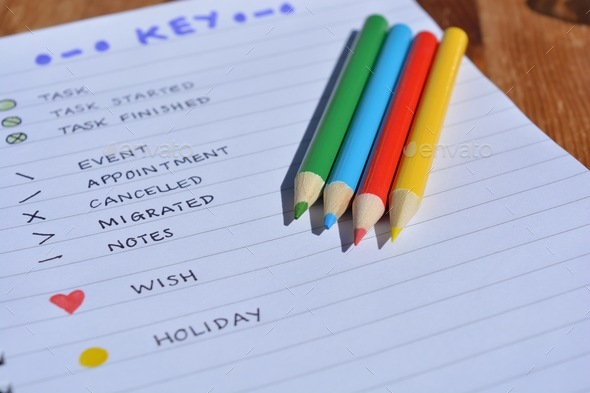 Bullet journal open at the Key page, with color pencils for colour ...