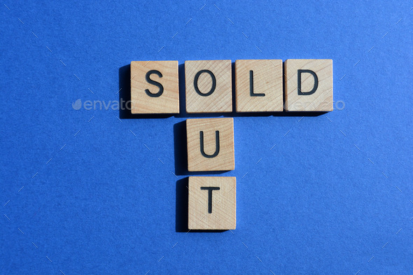 Sold Out, words in 3D wooden alphabet letters isolated on blue ...
