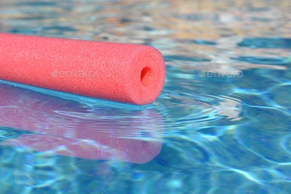 Pink pool noodle floating on water in swimming pool Stock Photo by ...