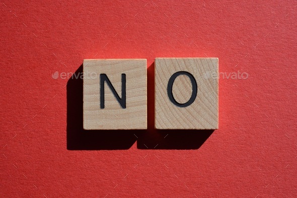 No, word in 3D wooden alphabet letters on a bright red background with ...