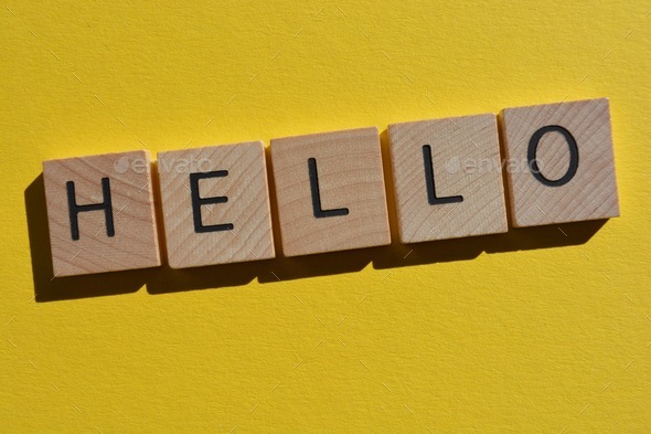 Hello in 3D wooden alphabet letters on a bright yellow background with ...