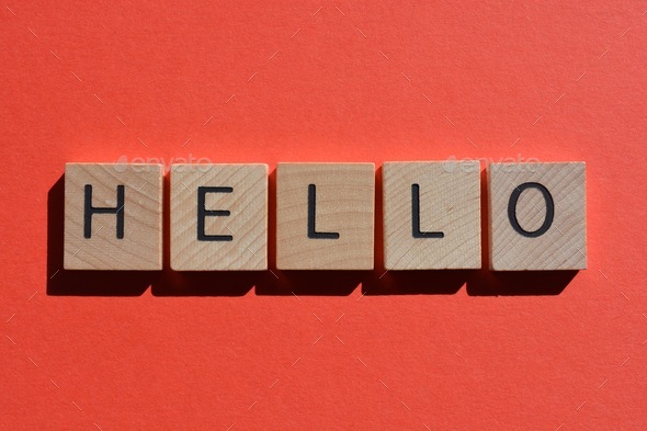 Hello in 3D wooden alphabet letters on a bright red background with ...