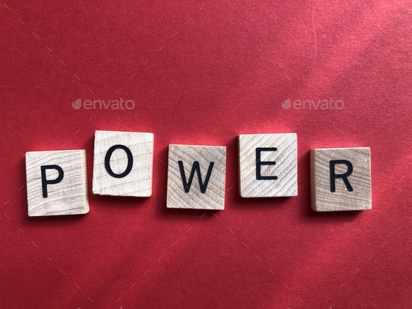 Power, word in 3D wooden alphabet letters isolated on a plain red ...