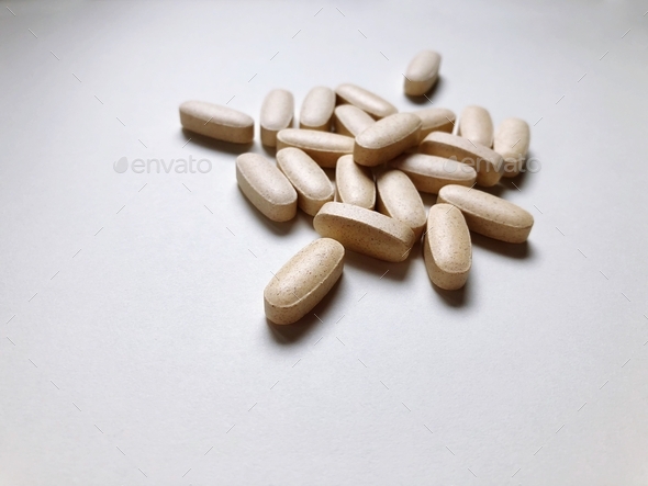 Healthcare and Medicine. Pile of generic tablets on a plain white ...