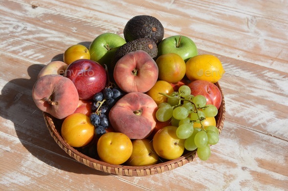 Organic fresh ripe fruits, including nectarines, peaches, grapes, plums ...