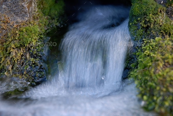 Water gushing from a natural mountain spring, slow exposure Stock Photo ...