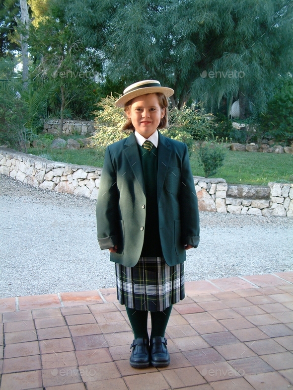 Little girl in generic school winter uniform, skirt, blazer and straw ...