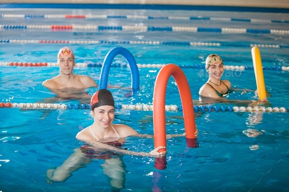 Group of happy people on aqua fitness in swimming pool. Stock Photo by ...