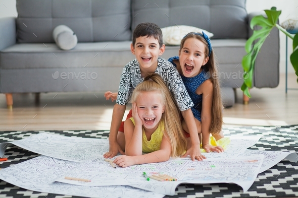 Gen z children play and draw on coloring book Stock Photo by olesyaklyots