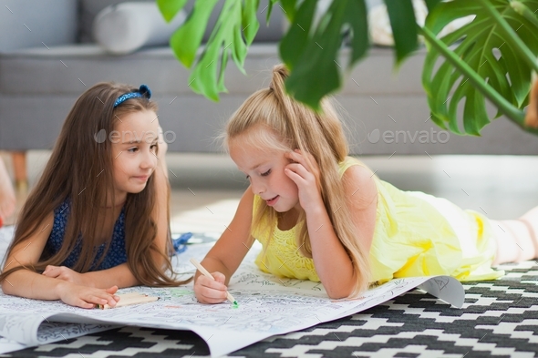 Gen z children play and draw on coloring book Stock Photo by olesyaklyots