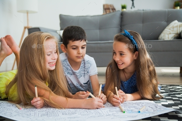 Gen z children play and draw on coloring book Stock Photo by olesyaklyots