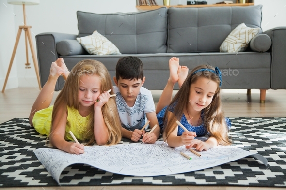 Gen z children play and draw on coloring book Stock Photo by olesyaklyots