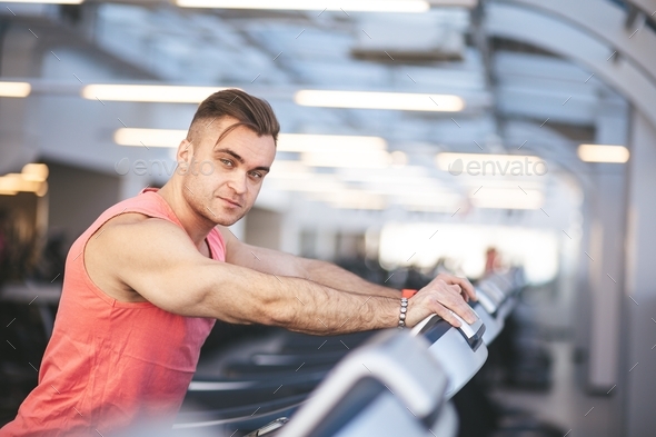Athletic fit man in fitness health centre posing on treadmill. Stock ...