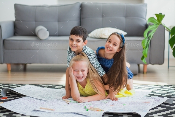 Gen z children play and draw on coloring book Stock Photo by olesyaklyots