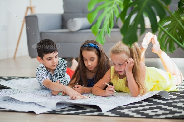Gen z children play and draw on coloring book Stock Photo by olesyaklyots