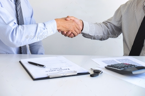 Real estate agent and customers shaking hands together celebrating ...