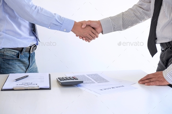 Real estate agent and customers shaking hands together celebrating ...
