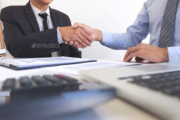 Real estate agent and customers shaking hands together celebrating ...