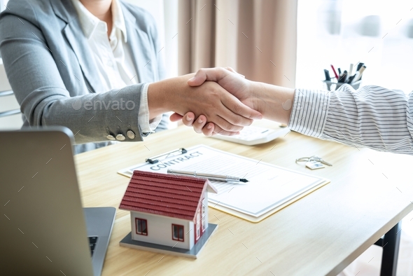 Estate agent and customers shaking hands together celebrating finished ...