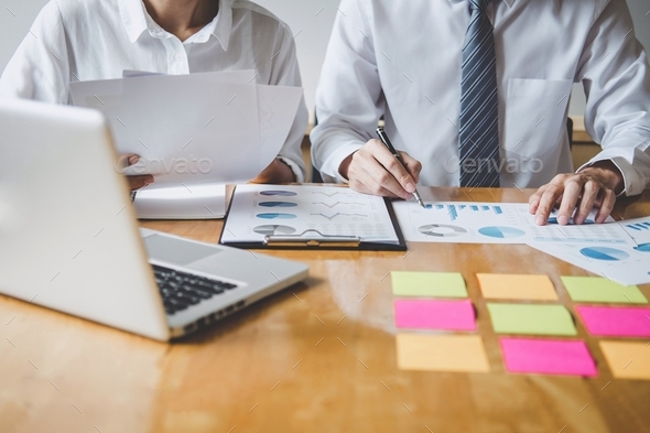 Executive team discussing the charts and graphs working in business ...