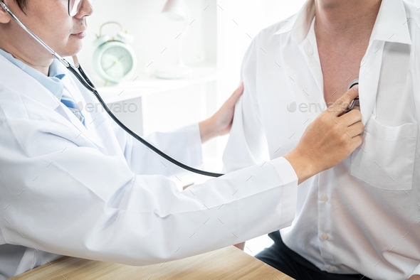 Doctor listening patient heartbeat with a stethoscope to diagnose heart ...