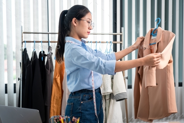 Women fashion designer stylist working and thinking decide making new ...